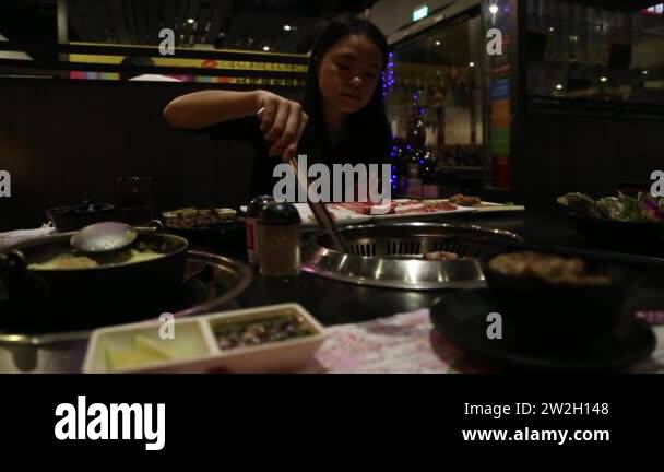 Asian girl happy making delicious food BBQ chinese meat in Taiwan in ...