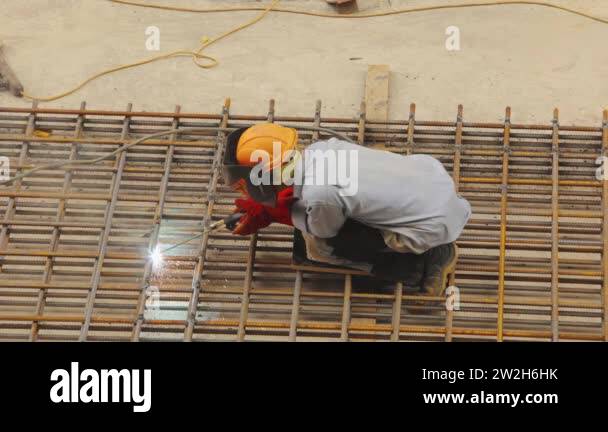 A welder welds a metal structure. Welding metal construction ...