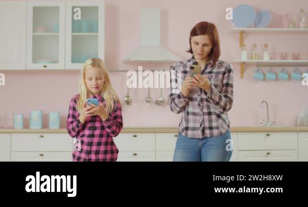 Young 30s mother and pre teen daughter surfing social media, texting ...