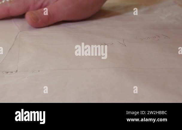 tailor reviewing patterns and hand drawings. In sewing and fashion ...