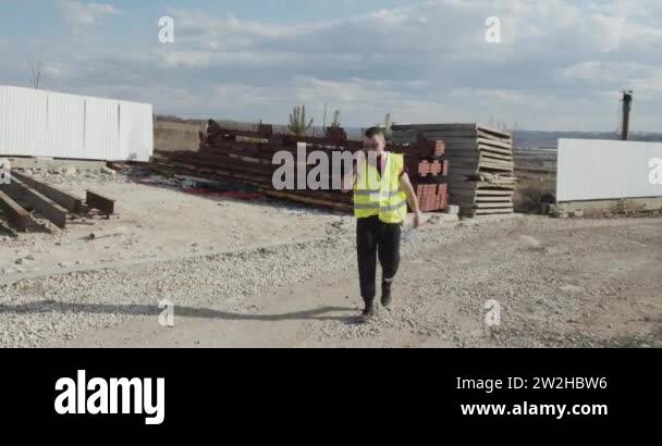 A man, a construction worker, an engineer who walks the construction ...