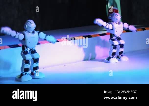 Humanoid robot dance. Group of cute robots dancing. Close up of smart robot dance show. Dancing ...