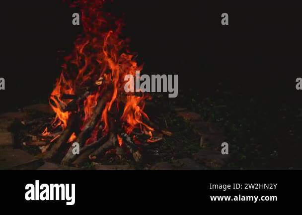 TIME REMAP, CLOSE UP: Large campfire burning inside a brick enclosed ...