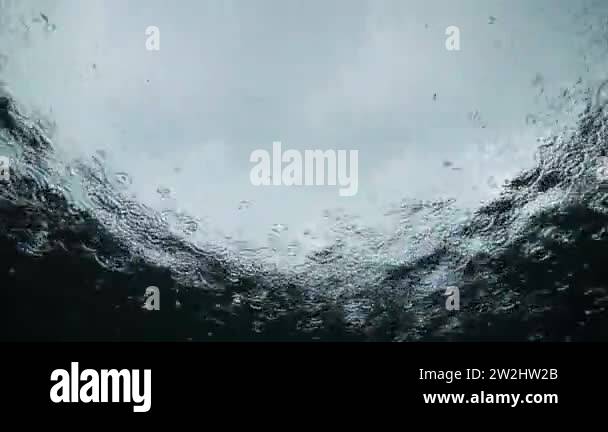 Little drops of rain falling over touching the surface of ocean water ...