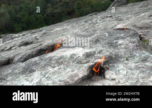 Flame of Methane Underground Emerges From Crack Between Rocks and Burns ...