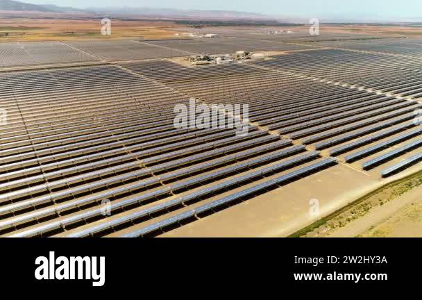 Aerial view of a farm of solar panels (solar cell) with its factory ...