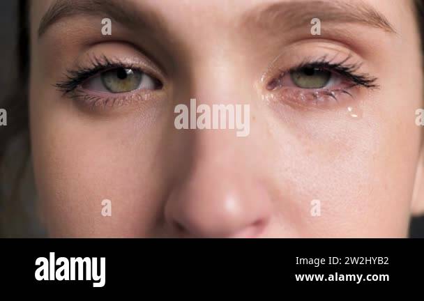 Watery eyes. Woman cries and looking at camera, flu, tonsillitis, colds ...