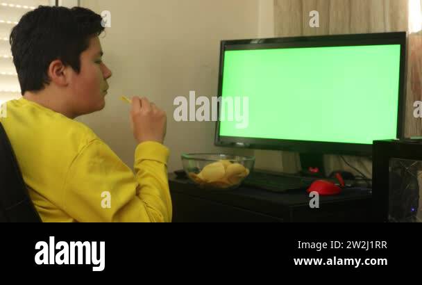 Young boy siting in front of green screen computer monitor Stock Video ...