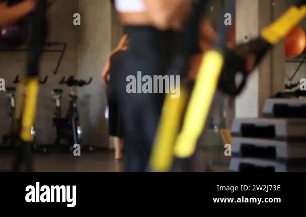 Beautiful girls learning using total body resistance exercise TRX for ...