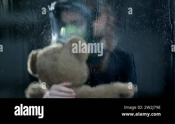 Worried Child Wears Gas Mask While Holding Teddy Bear Tight. It Is Dark ...