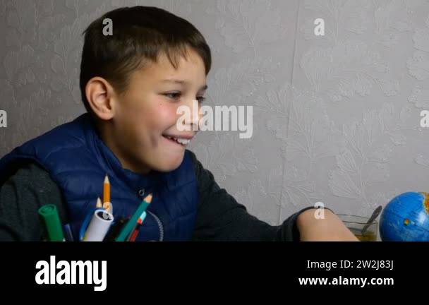 Distance learning. Funny schoolboy gets online education and does ...