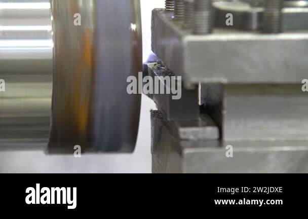 The lathe produces the metal part at the factory. Processing of the ...