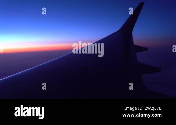Through the porthole, you can see the wings of the aircraft , which is ...
