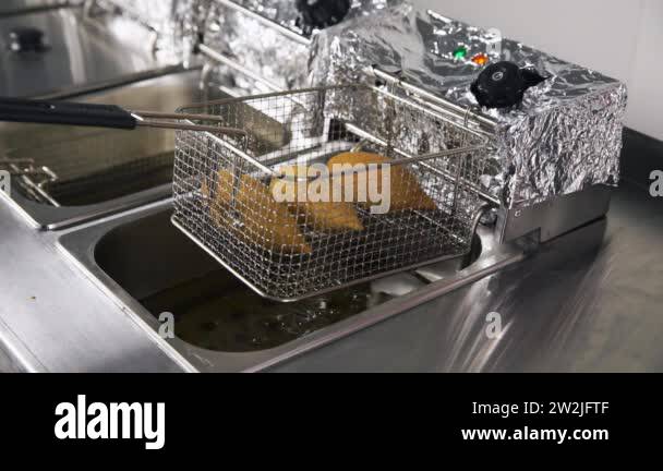 Concept of unhealthy junk very fat food. Deep frying of bakery pastry ...