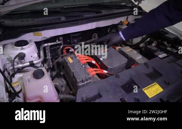 Close up man's hand in gloves points finger at the components of an ...