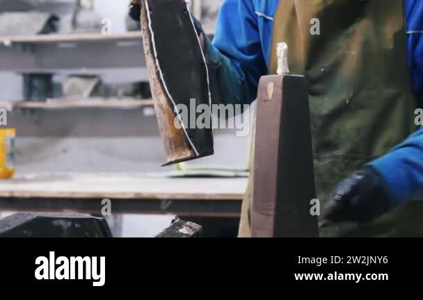 Concrete workshop - a craftsman putting a mold on a concrete product ...