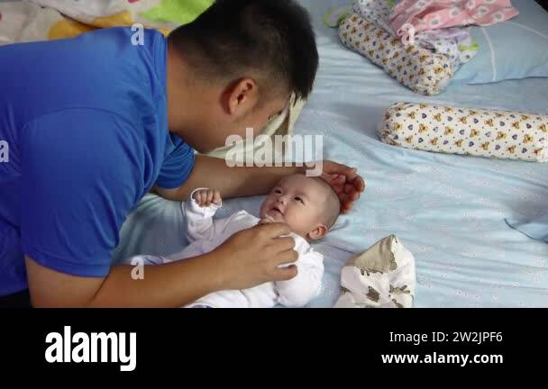 4K lifestyle footage of happy father playing with 5 month old baby boy ...