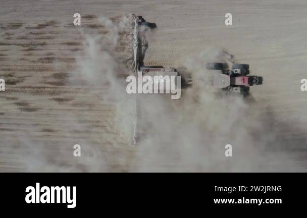 View from above, tractor working in a field. Tractor with a seeder, sow ...
