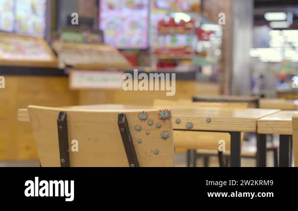 Coronaviruses on the back of a chair and on a table in a cafe in a ...
