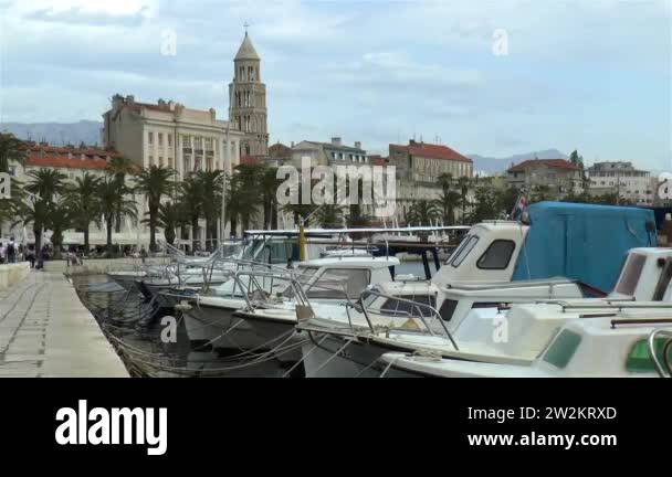 People, boats and palm trees in the City of Split, Croatia. People ...
