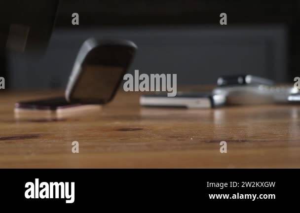 Old scratched retro mobile phones fall on the office Desk and break and ...