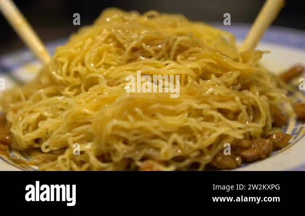 Slow motion people eating a famous noodles with meat for lunch in an ...