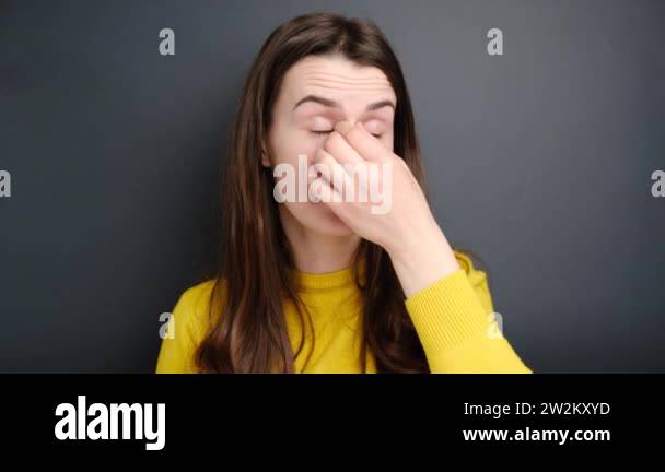 Pain eyes concept. Stressed young woman massaging nose bridge, feeling ...