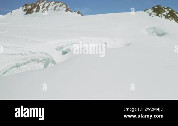 Overhead flight close above snow collapse, cave hollow on white ...