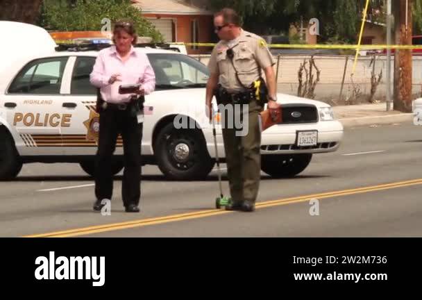 Officer using surveryor's wheel at crime scene Stock Video Footage - Alamy