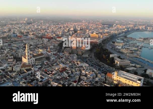 Drone flight over the italian city by the sea at sunrise. View of ...