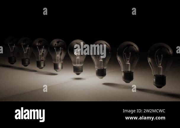 Line of light bulbs with middle light bulb gaining brightness ...