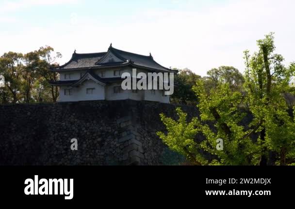 4K, Guard House of main tower Osaka Japanese Castle behind rock wall ...