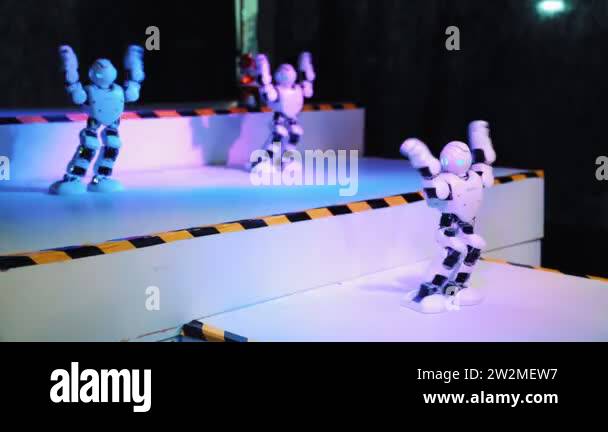 Humanoid robot dance. Group of cute robots dancing. Close up of smart ...