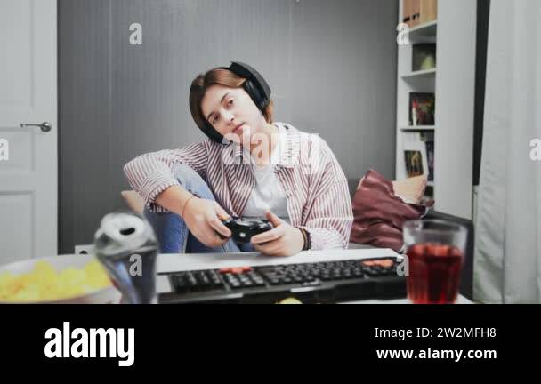 Boring Young Gamer Girl playing in Video Games on a Console with a ...