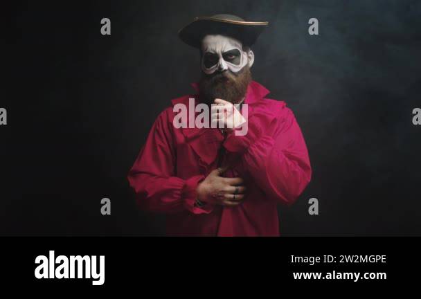 Man dressed up like a scary pirate in red shirt and with a hat Stock ...