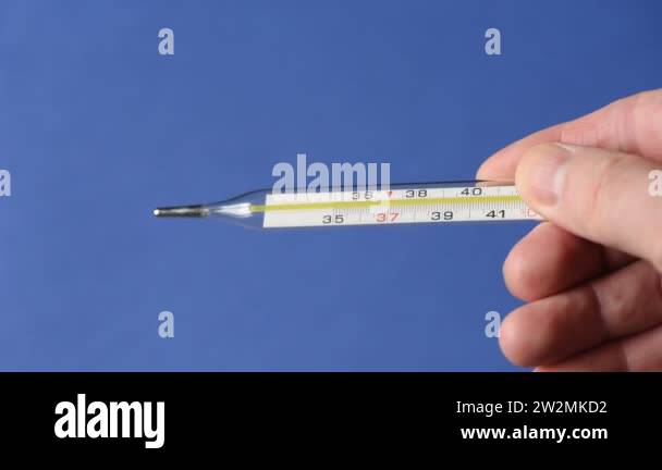 A glass mercury thermometer shows the normal temperature of the human ...