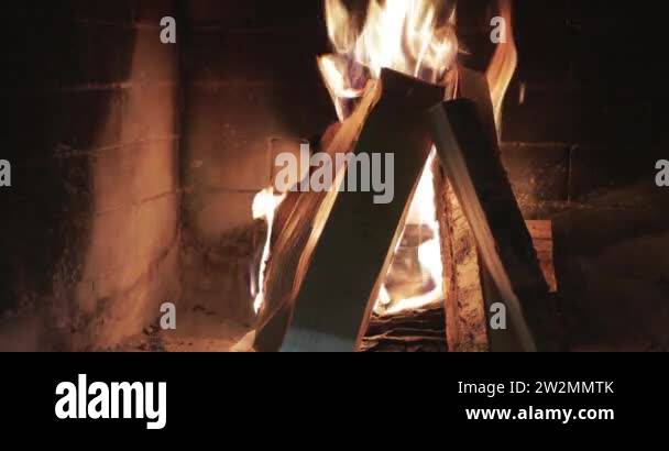 The big fire with firewood in a fireplace, bonfire burning, Brick walls ...