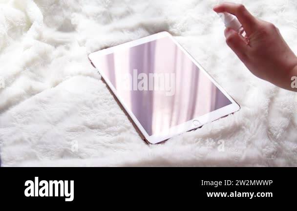 Human hand uses and puffs an antibacterial agent on the electronic ...