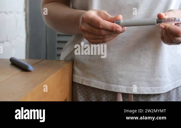 Close-up of a woman makes an injection of insulin in the stomach ...