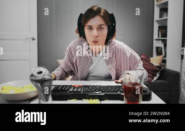 Excited Pro Gamer Girl Playing in Video Game and eating snacks. Woman ...