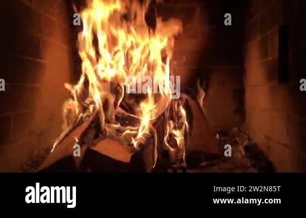 The big fire with firewood in a fireplace, bonfire burning, Brick walls ...