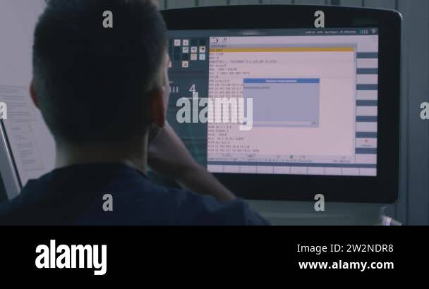CNC machine control screen. a man works on a CNC machine monitor ...
