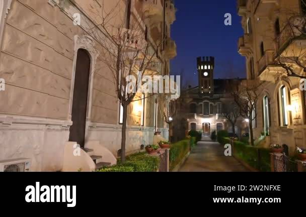 Night footage of the driveway with hedges of a courtyard from the early ...