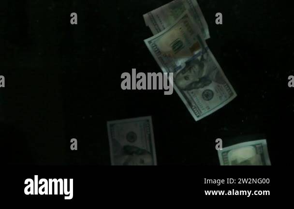 Falling flying american canadian dollar banknotes on a black background ...
