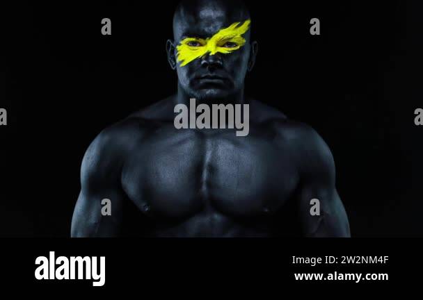 Man sports fan and bodybuilder athlete with yellow color on face art ...
