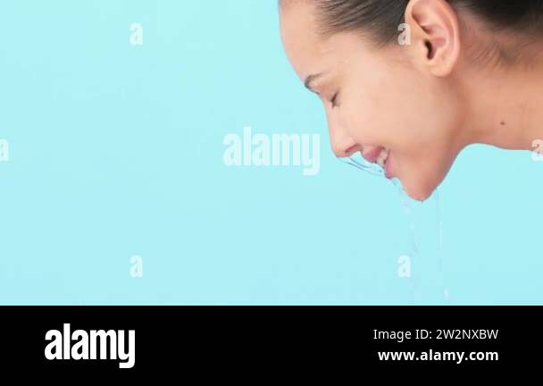 Woman washing her face with water. Young adult girl is washing face ...