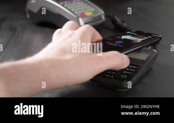 NFC Technology. The user makes contactless payment by mobile phone ...