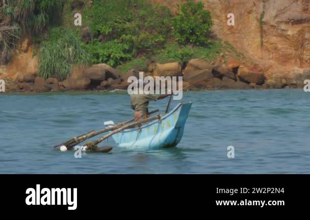 Fisherman with rod in traditional wooden boat with balancer Stock Video ...