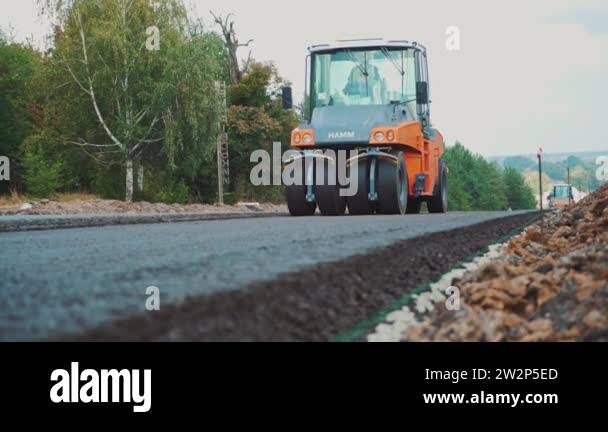 Modern asphalt roller press hot asphalt while making a new road in ...