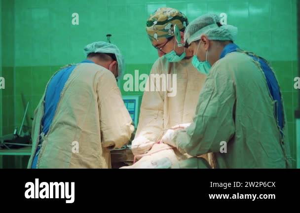 Surgeon takes sterile instrument and does the operation with the help ...